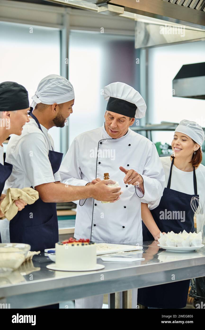 mature good looking chief cook in white hat helping his interracial ...
