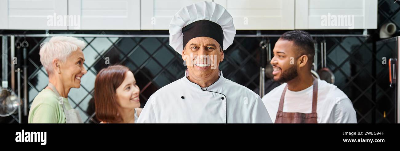 focus on happy chef with cake smiling at camera with his blurred ...