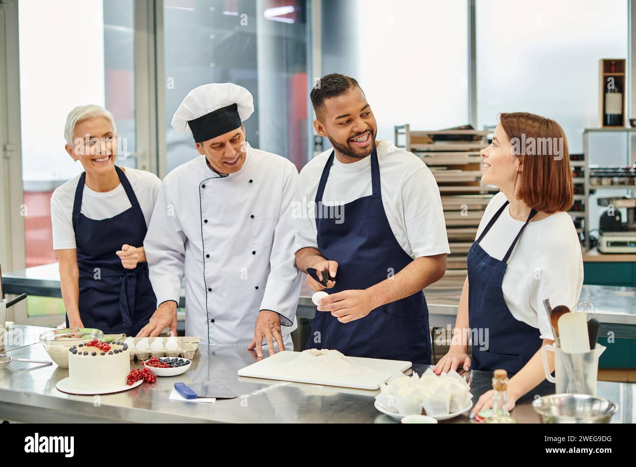 joyous african american male chef breaking egg and smiling happily at ...