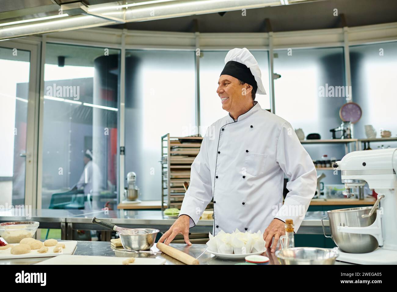 joyful handsome mature chief cook in white hat smiling happily and ...