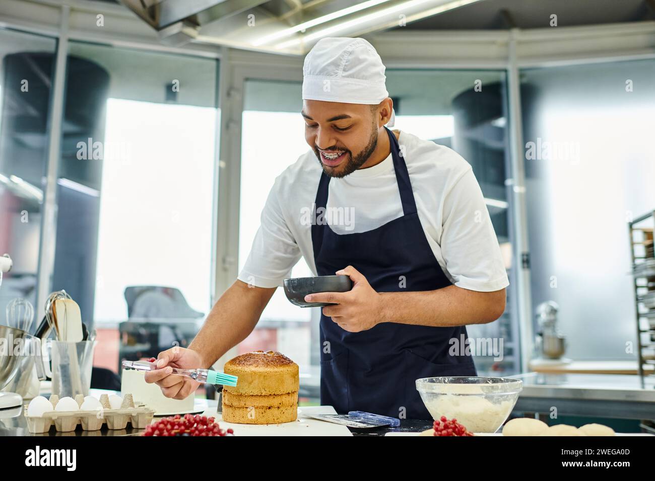 jolly handsome african american chef in blue toque and apron using ...