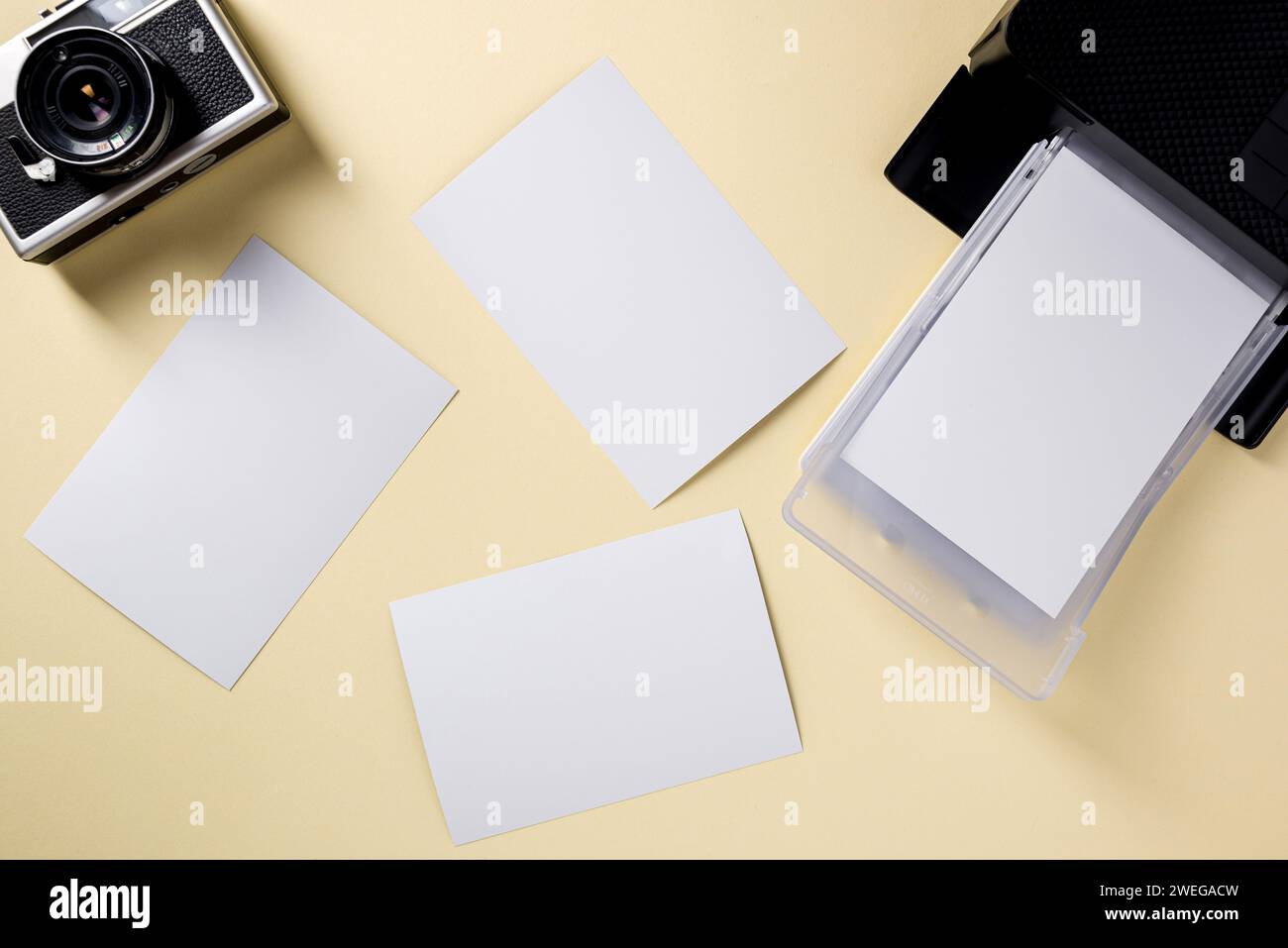 Top view of retro camera, blank photo papers and mobile photo printer ...