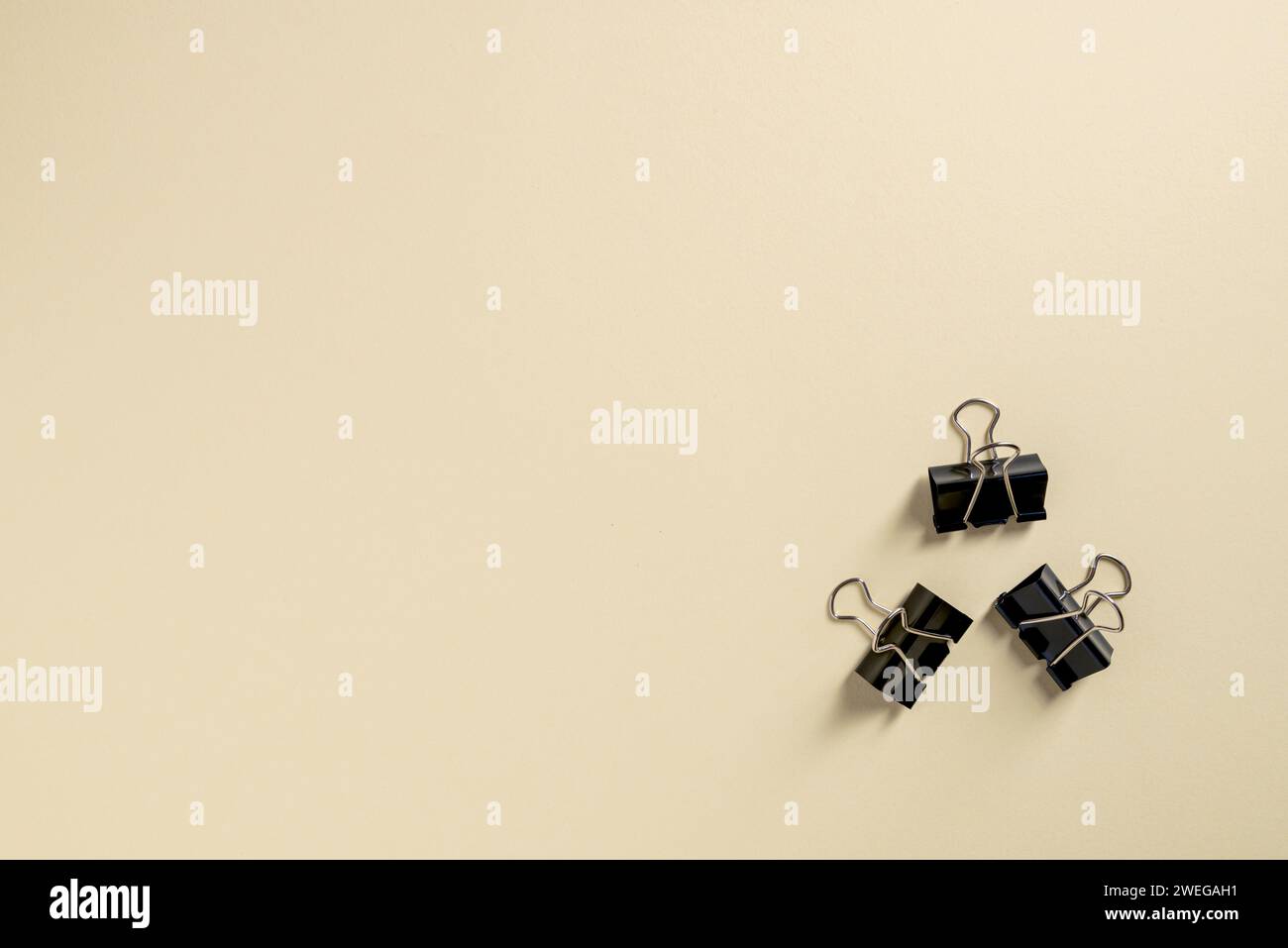 Black binder paper clip on yellow background Stock Photo - Alamy