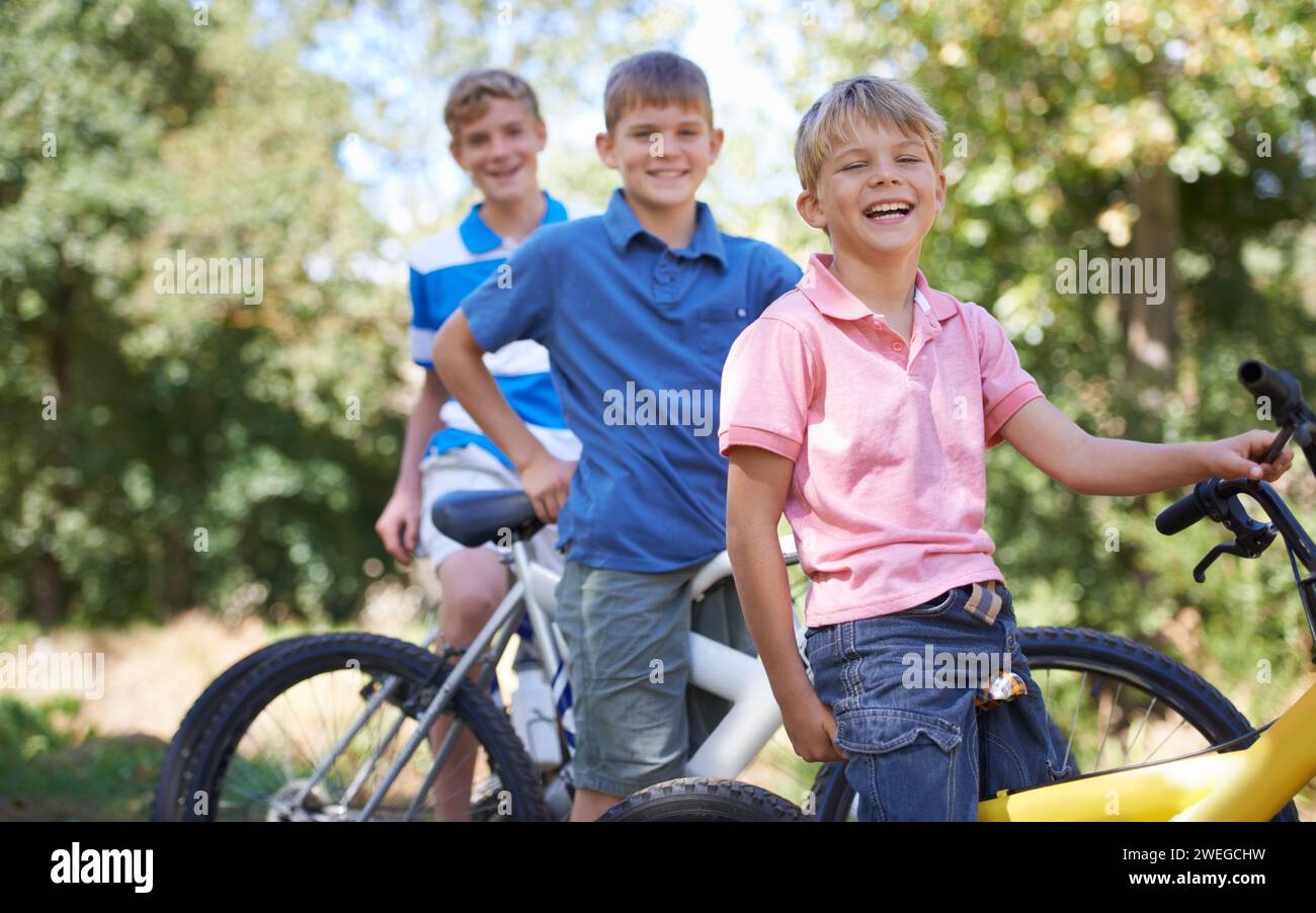 Nature, bicycle and portrait of boy kids riding in outdoor field, park ...