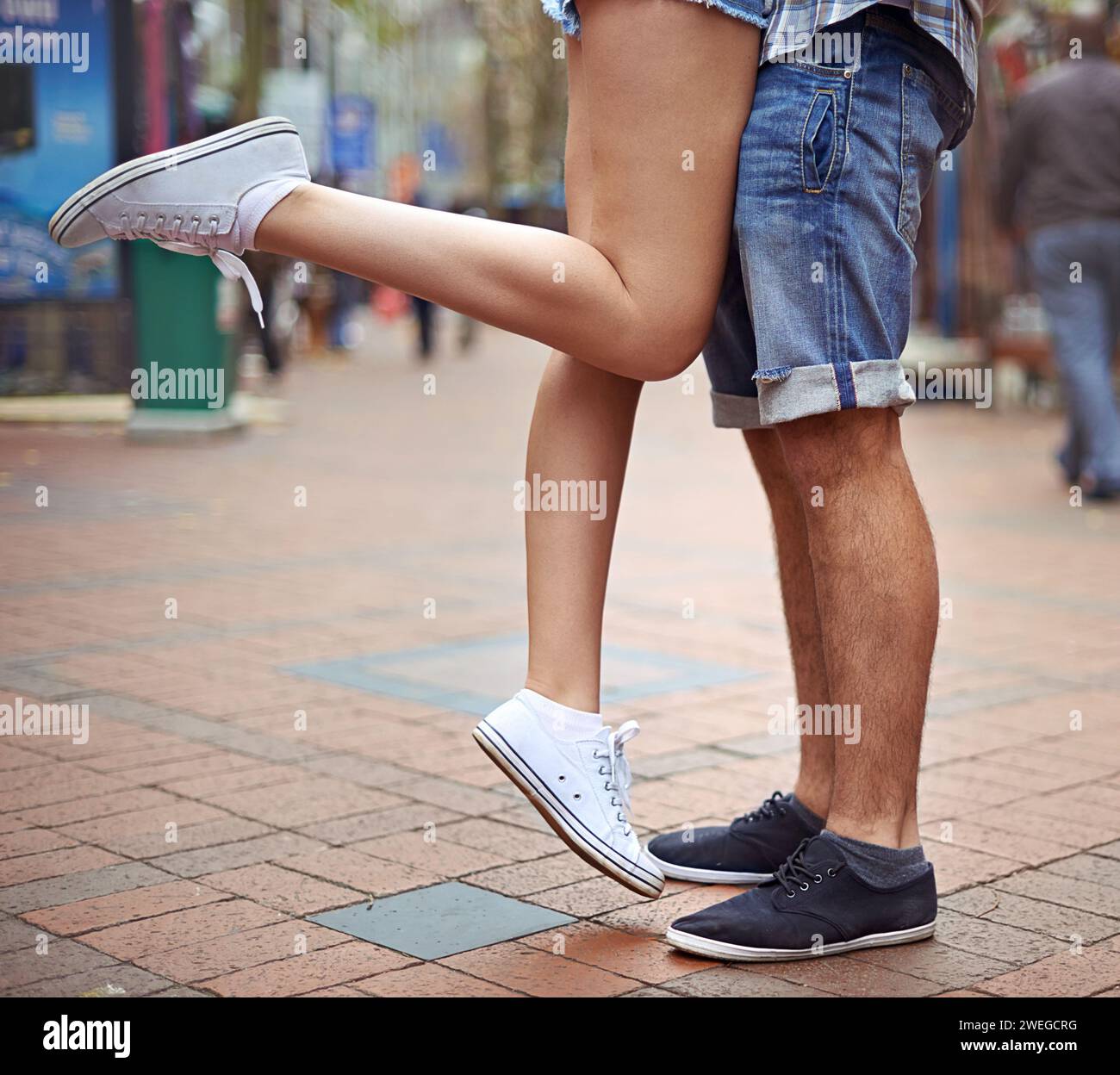 Legs, love and travel with couple hugging in city together for ...