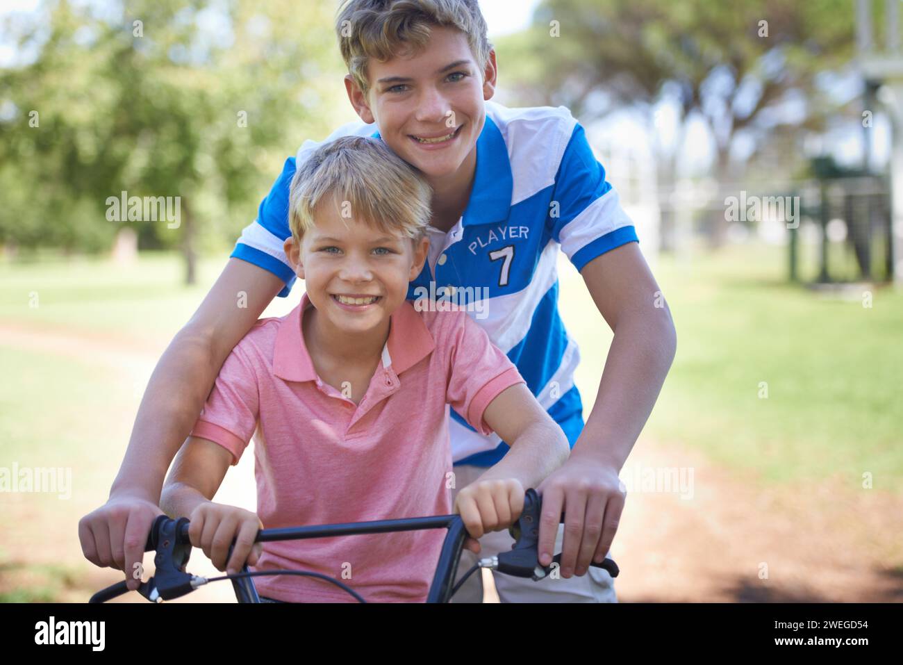 Nature, smile and portrait of children on bicycle riding in outdoor ...