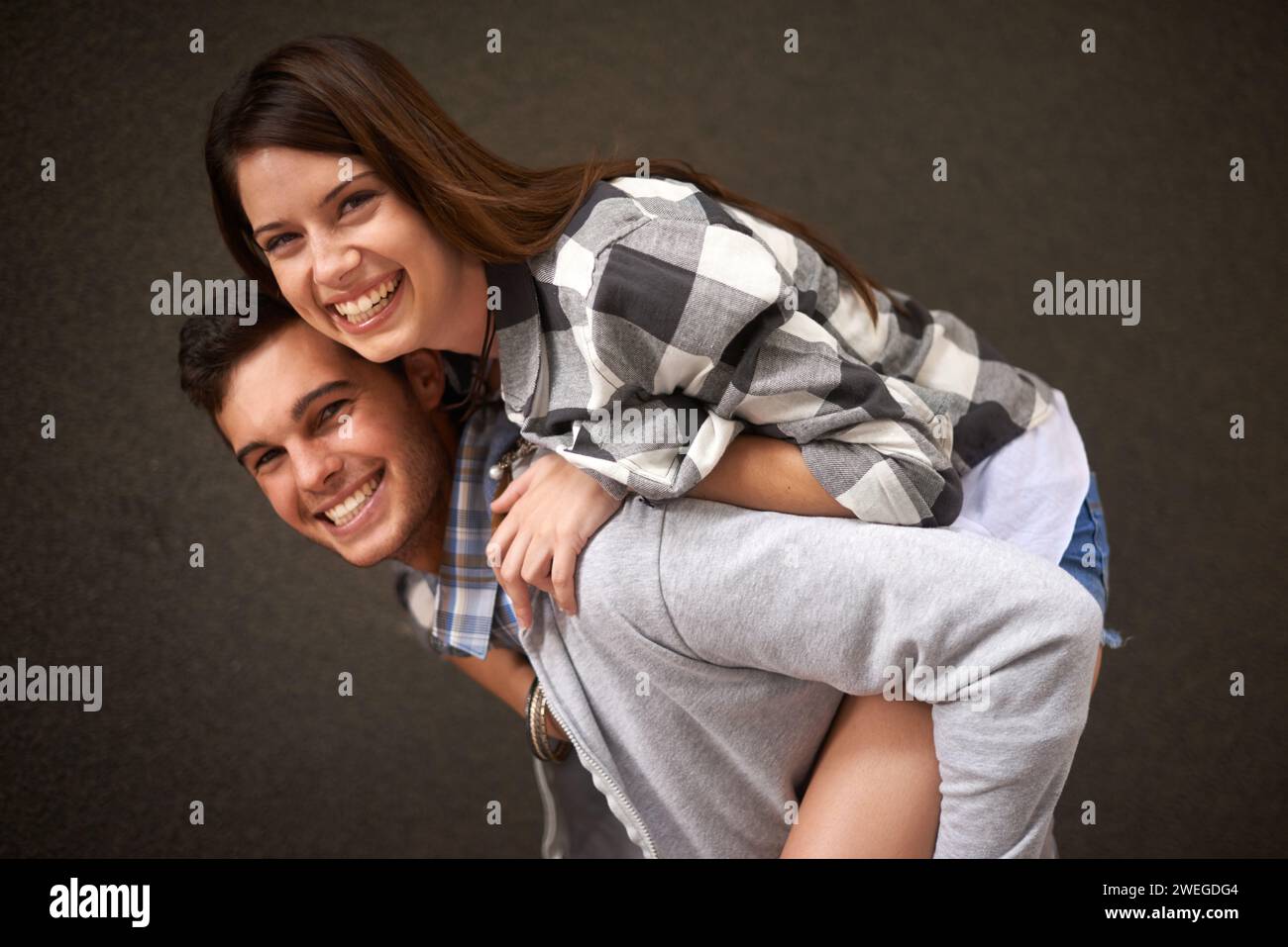 Smile, hug and portrait of couple piggyback ride, bond and having ...