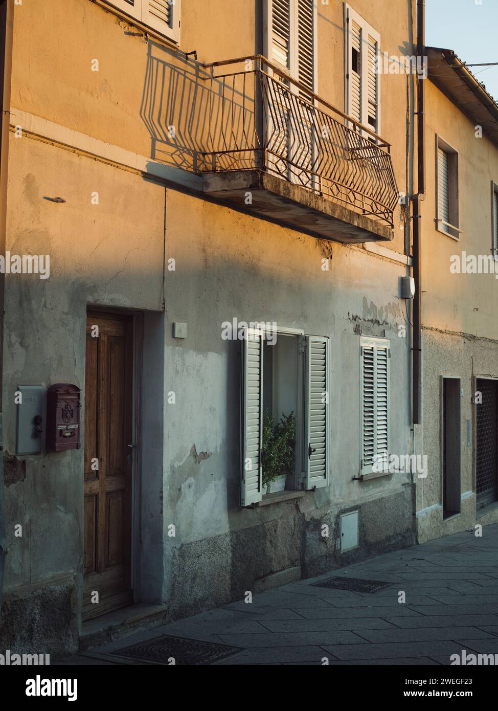 Vertical view of a facade of an Italian two-story building in an old ...