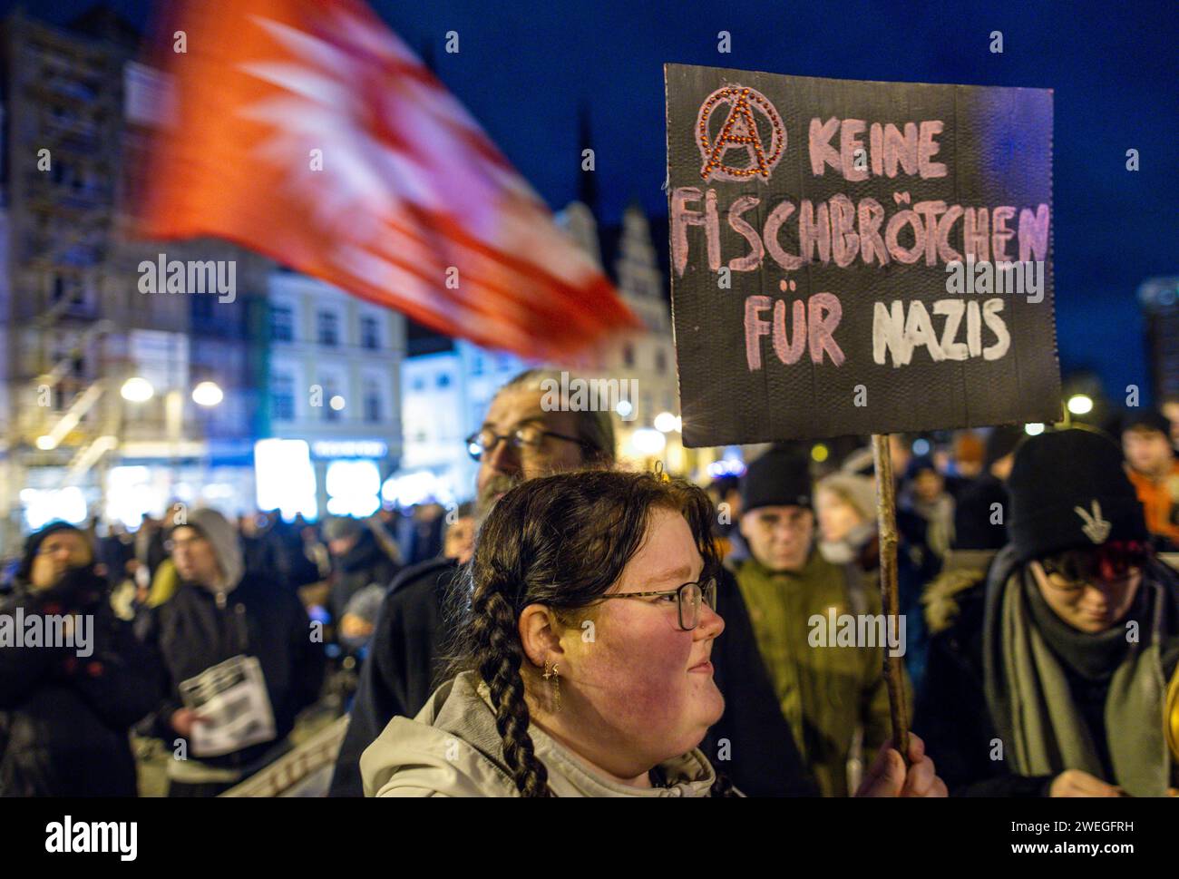 Rostock, Germany. 25th Jan, 2024. A participant in the demonstration ...