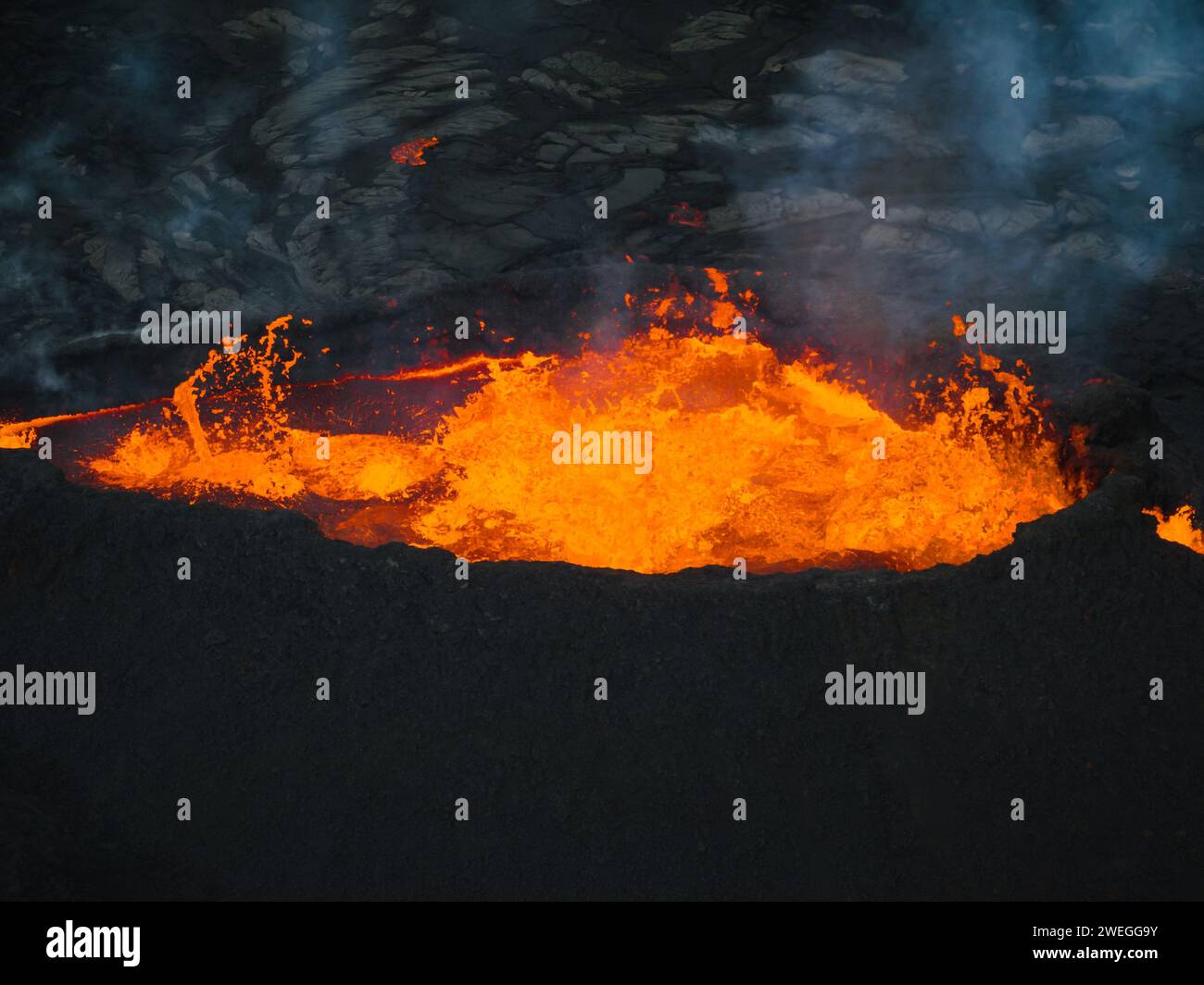 Volcano eruption in Iceland, summit crater, gas expulsion, and molten ...