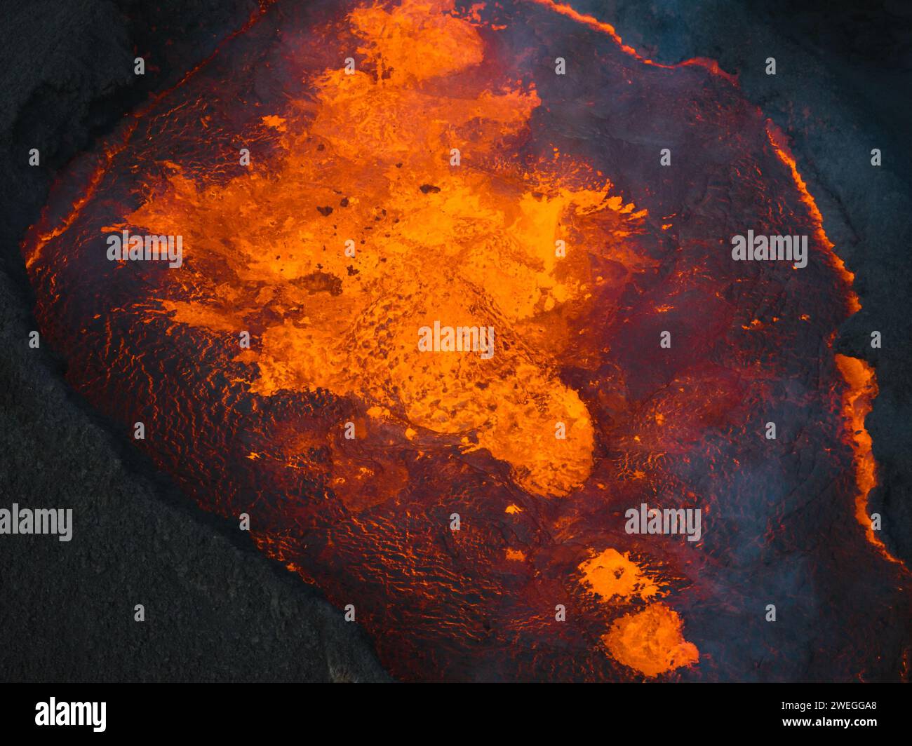 Awesome close up view of boiling red lava lake inside the active ...
