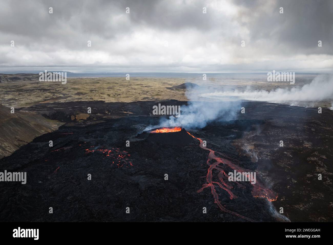 Apocalyptic surroundings of an erupted volcano, red hot lava boiling ...