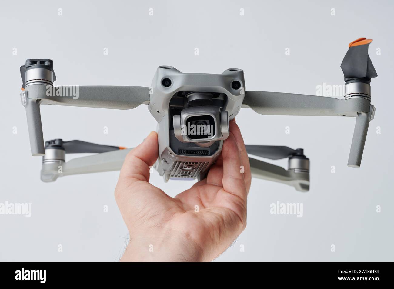 Gray drone with camera in hand isolated on white studio background ...