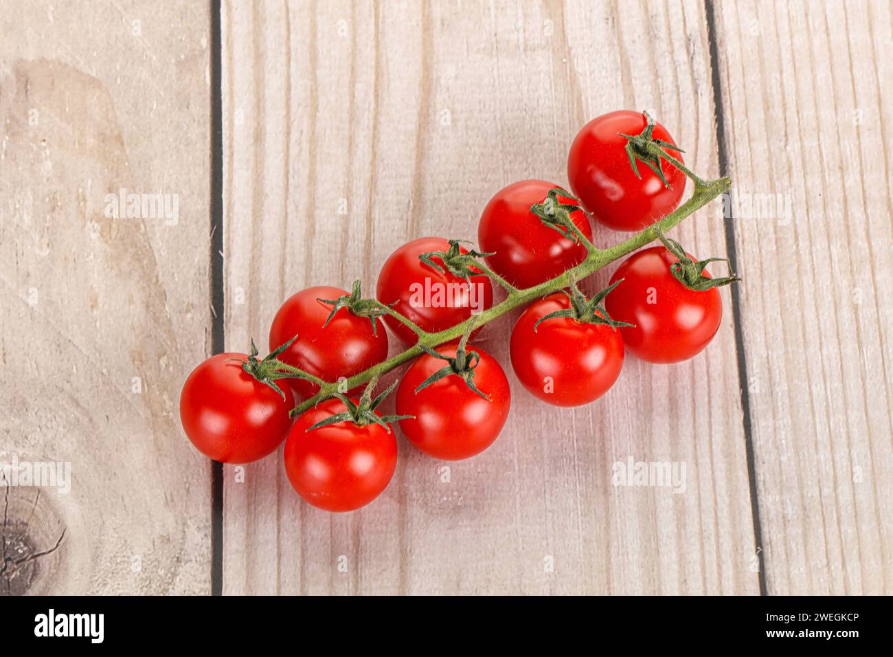 Ripe sweet cherry tomato branch isolated Stock Photo - Alamy