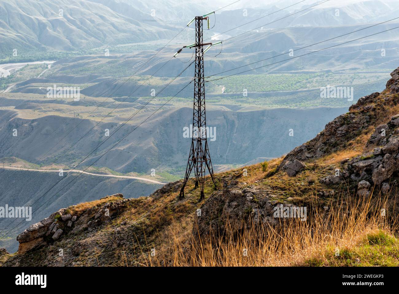 Mountain landscape with high voltage power line mast Stock Photo - Alamy