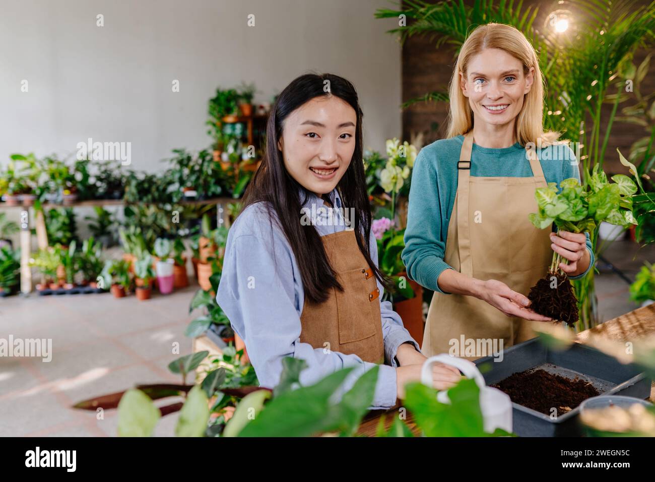 Portrait of business owner and her assistant wear uniforms, different ...