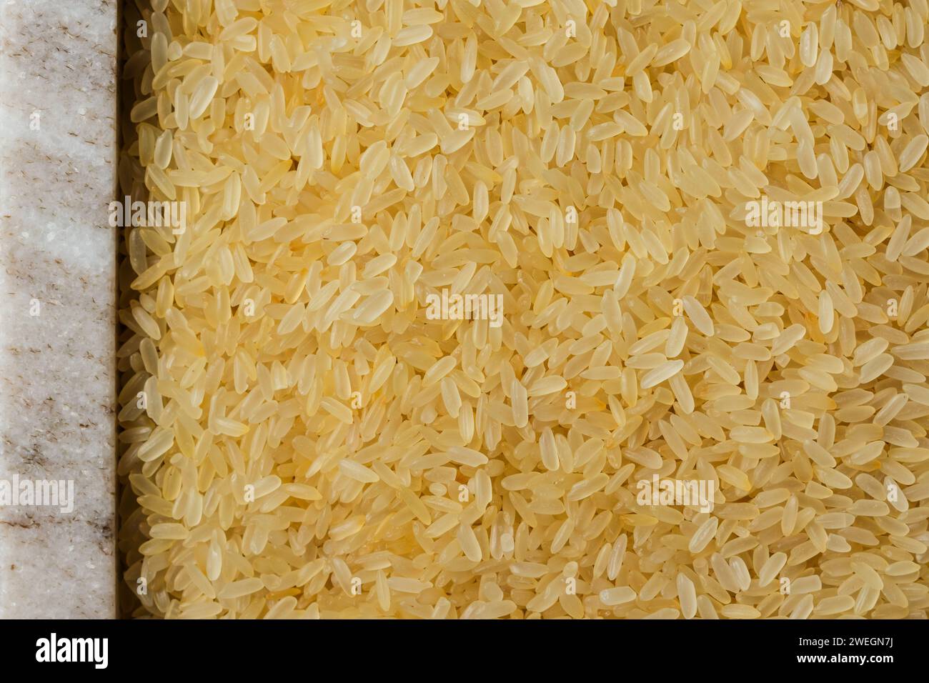 Uncooked golden rice grain hi-res stock photography and images - Alamy