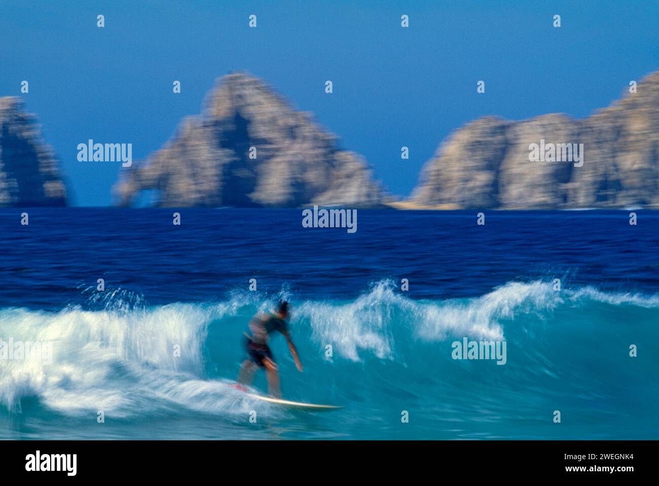 Surfing with El Arco in the background, Cabo San Lucas, Baja California ...