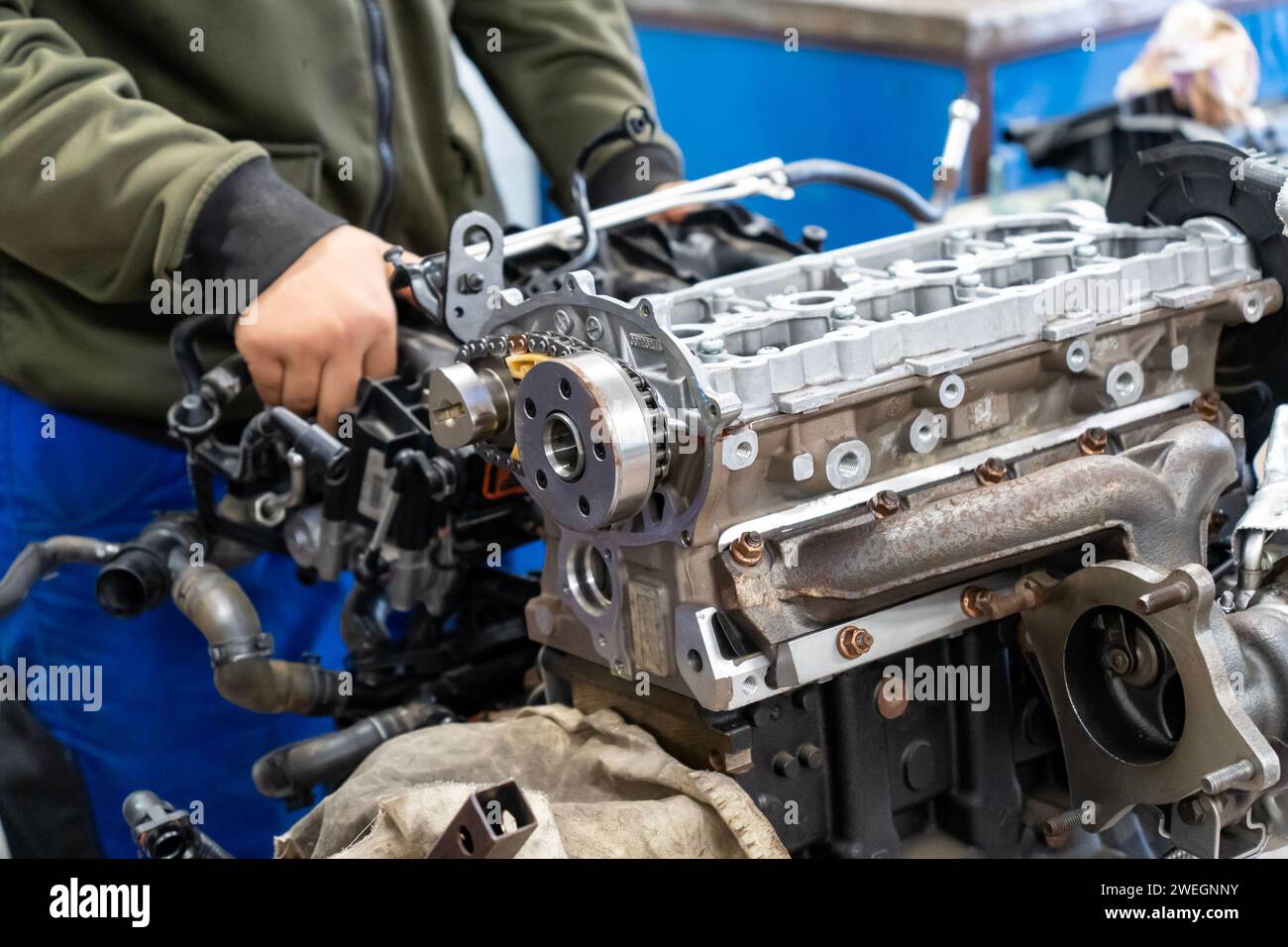 Auto mechanics assembling a disassembled car engine in a workshop Stock ...
