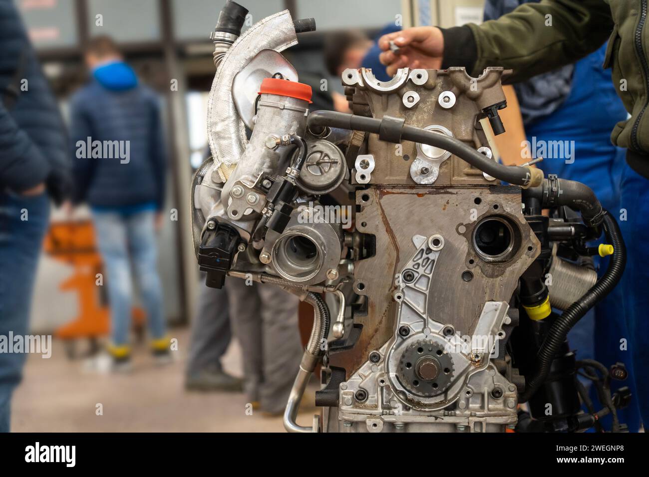Auto mechanics assembling a disassembled car engine in a workshop Stock ...