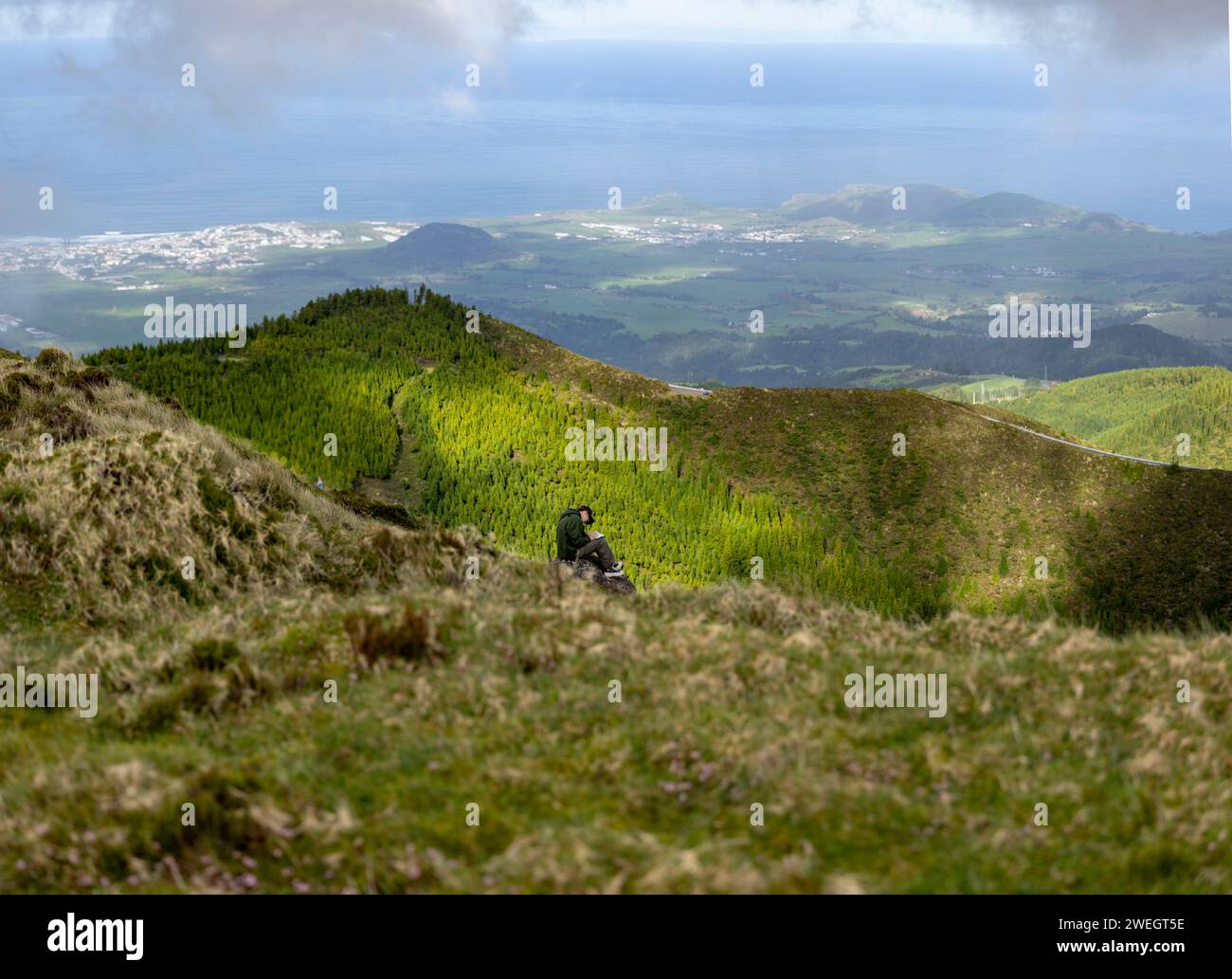 Lonely painter sitting on the top of a mountain in Lagoa do Fogo "Fire ...