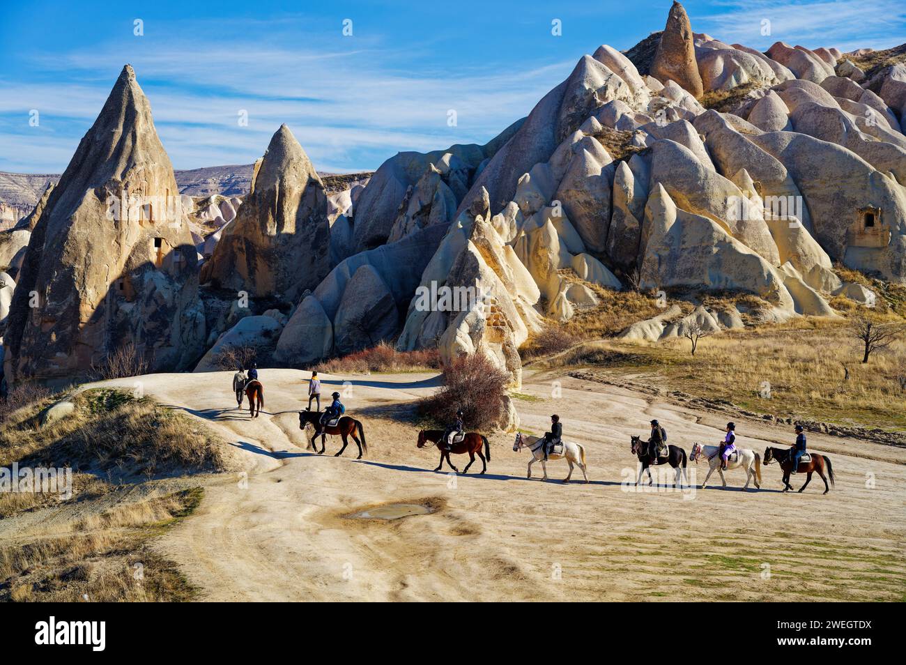 People riding horses on the Rose Red Valley in Cappadocia, Turkey ...