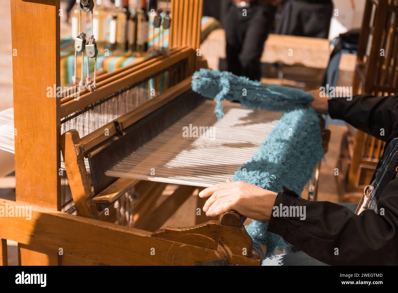 Master weaver is weaving the tapestry with diverse bright threads ...