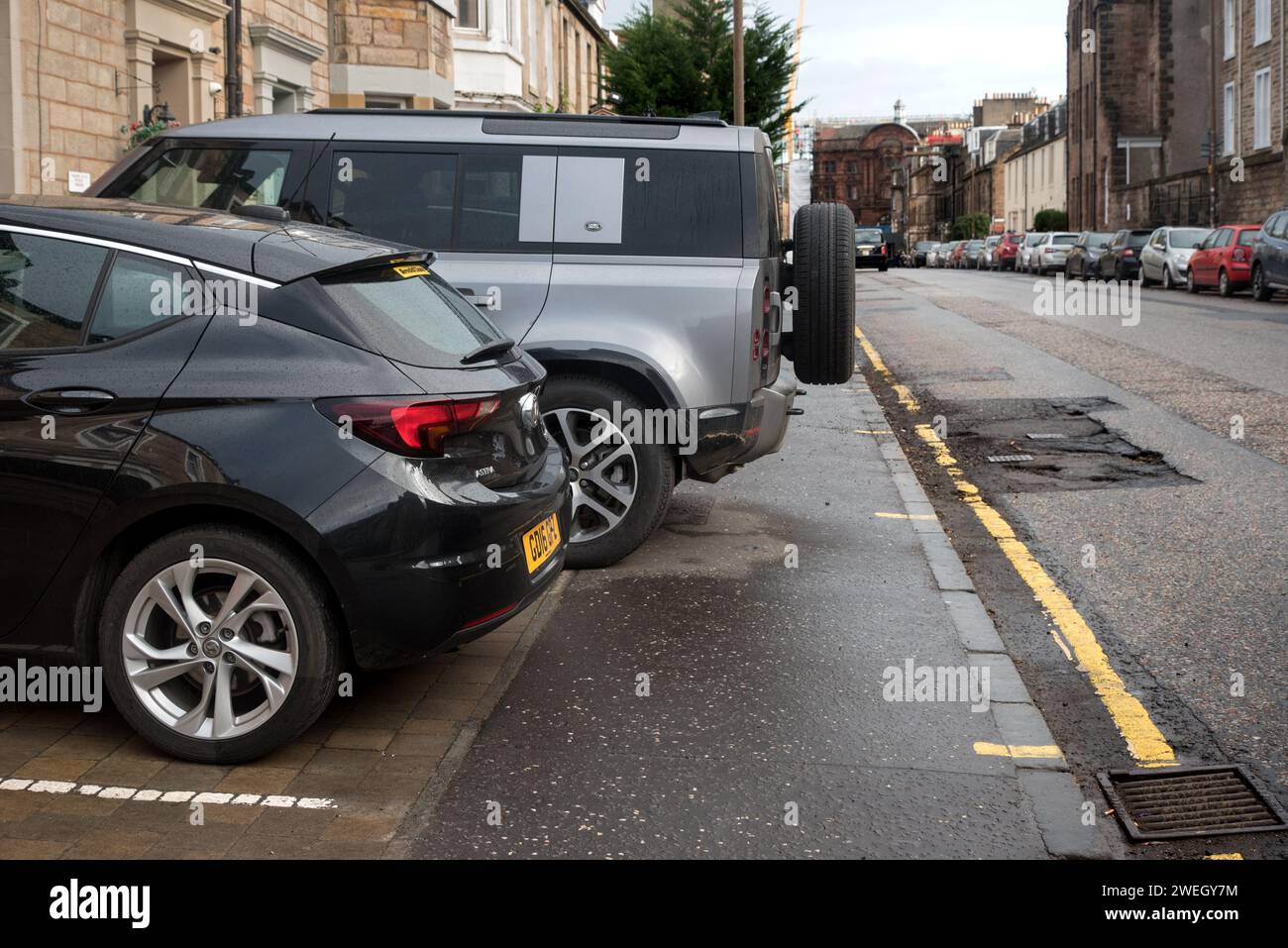 Vehicle too long for parking space and obstructing the pavement in ...