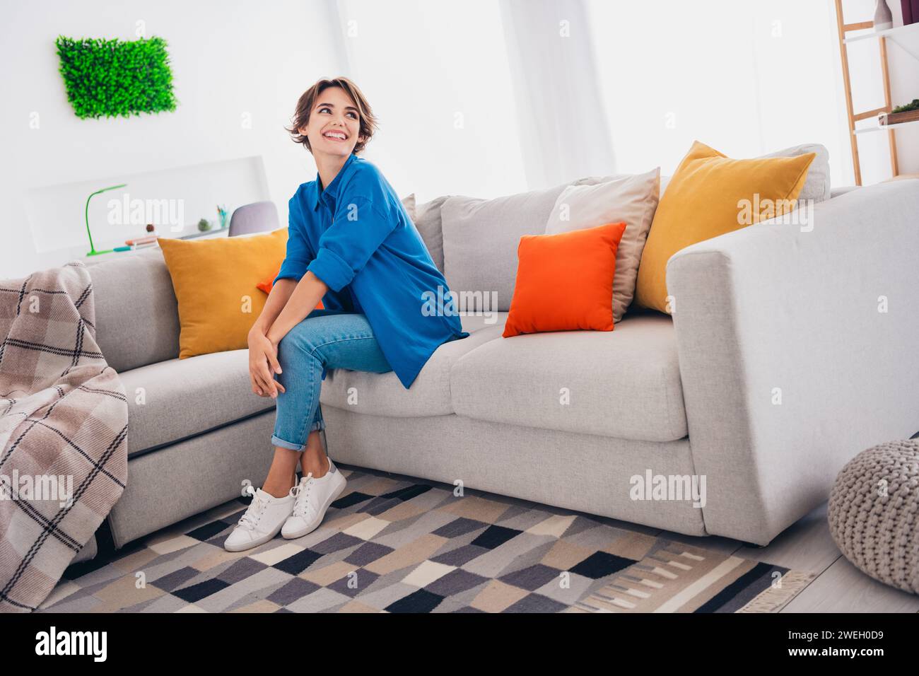 Full size photo of nice peaceful girl sit comfy couch look interested ...