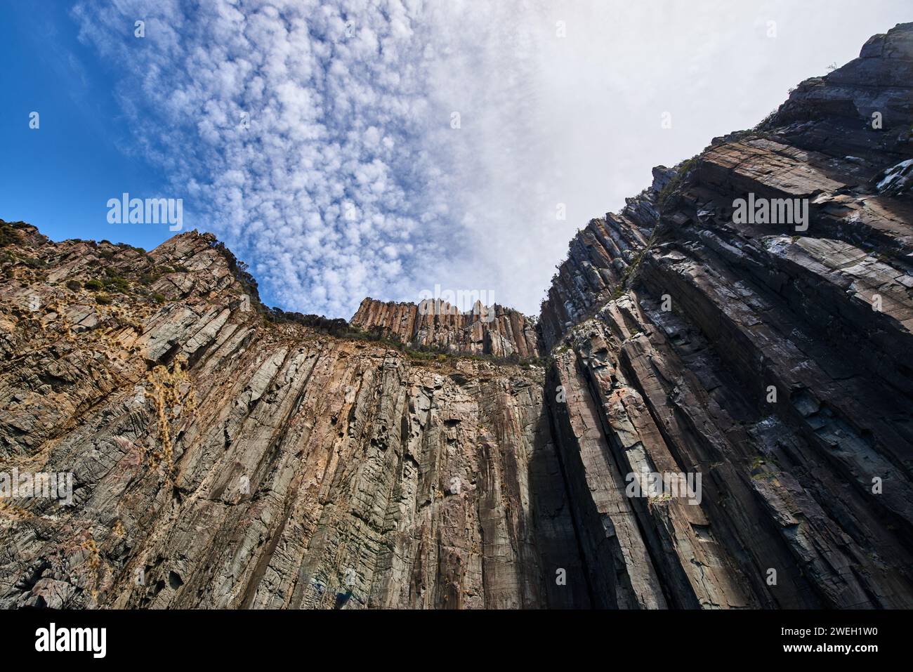 A majestic rock formation with towering rocks against a vibrant blue ...