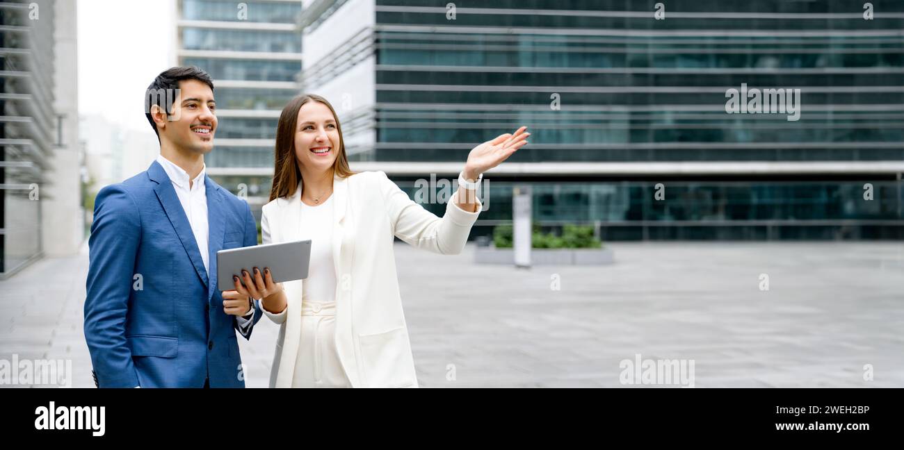 A professional woman gestures expansively, explaining a concept to her ...