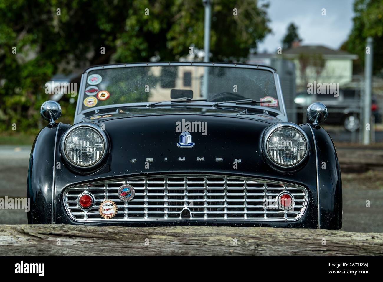 A Vintage Triumph Spitfire car parked behind a log Stock Photo - Alamy