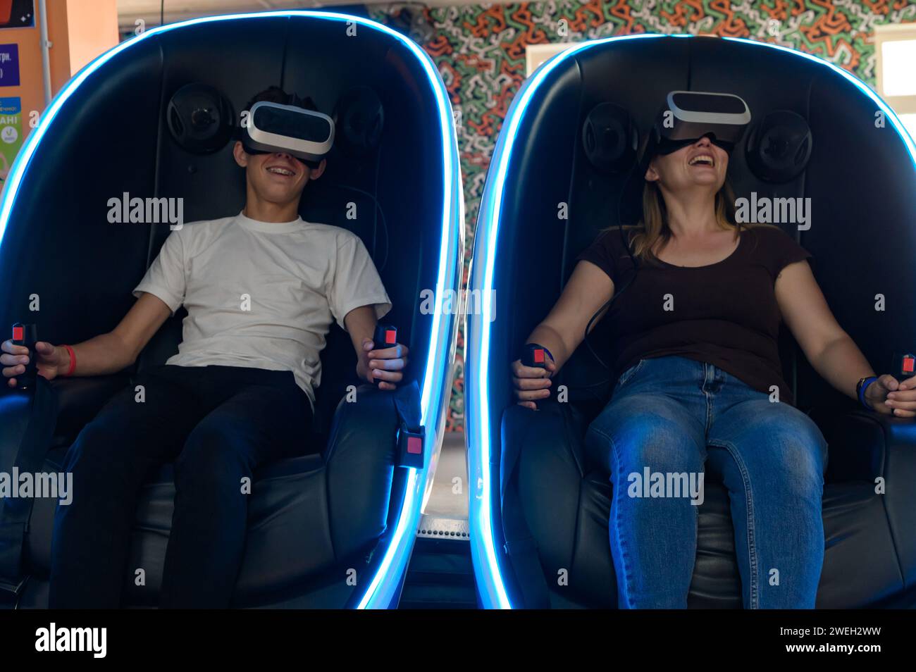 Virtual reality attraction, son and mother experience adrenaline from ...