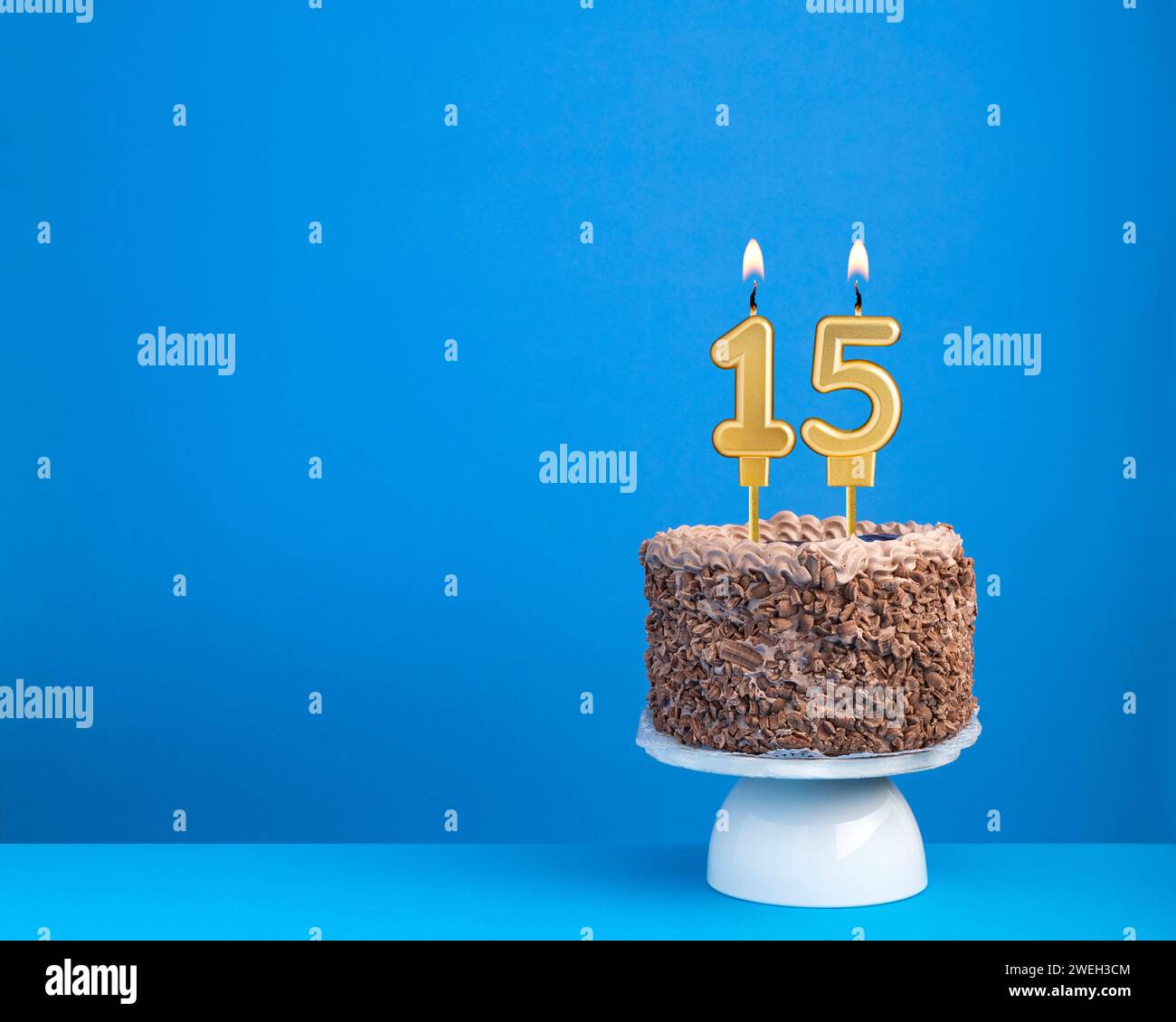 Birthday cake with burning candle number 15 hi-res stock photography ...