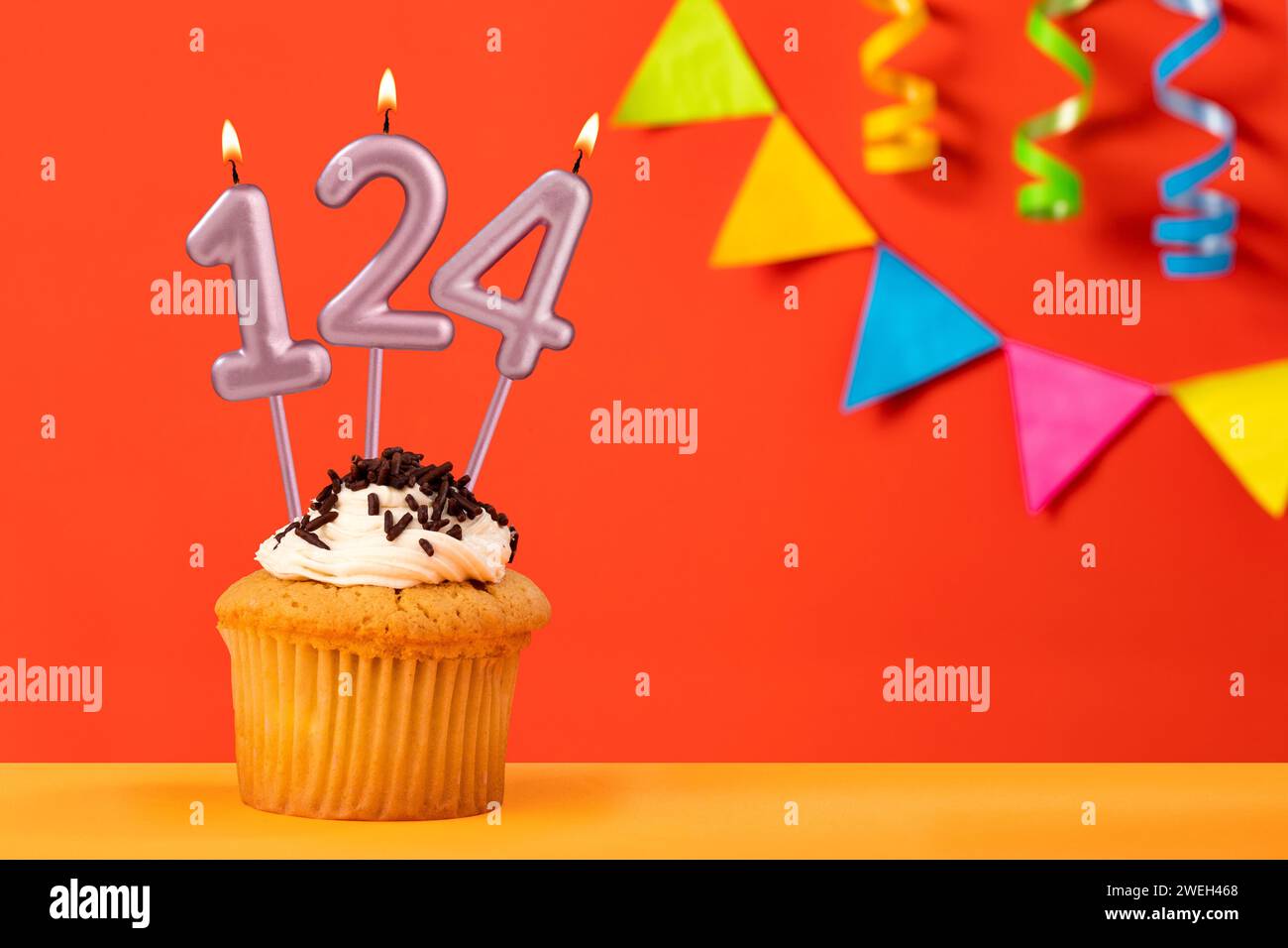 Number 124 Candle - Birthday cupcake on orange background with bunting ...