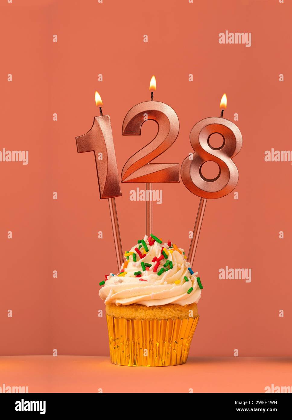 Birthday cupcake with candle number 128 - Coral fusion background Stock ...