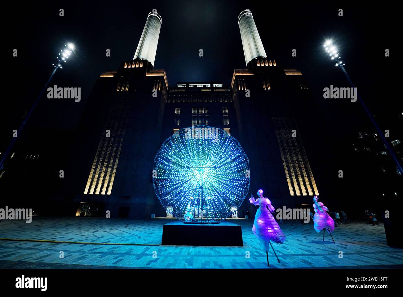 Illuminated stiltwalkers pass by Singularity by Squidsoup, one of the ...