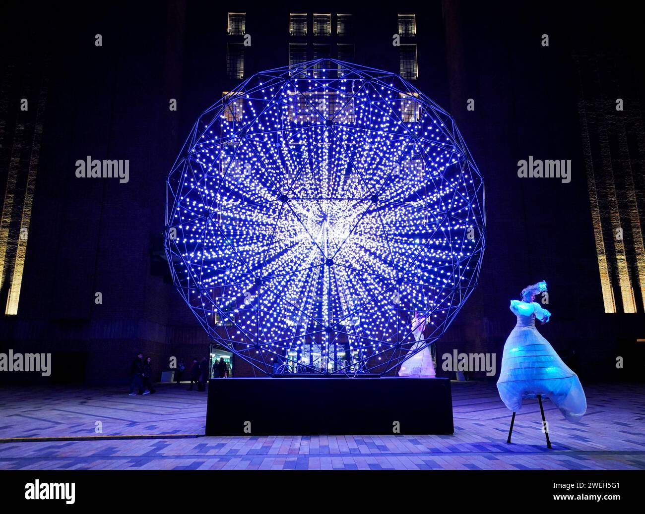 Illuminated stiltwalkers pass by Singularity by Squidsoup, one of the ...