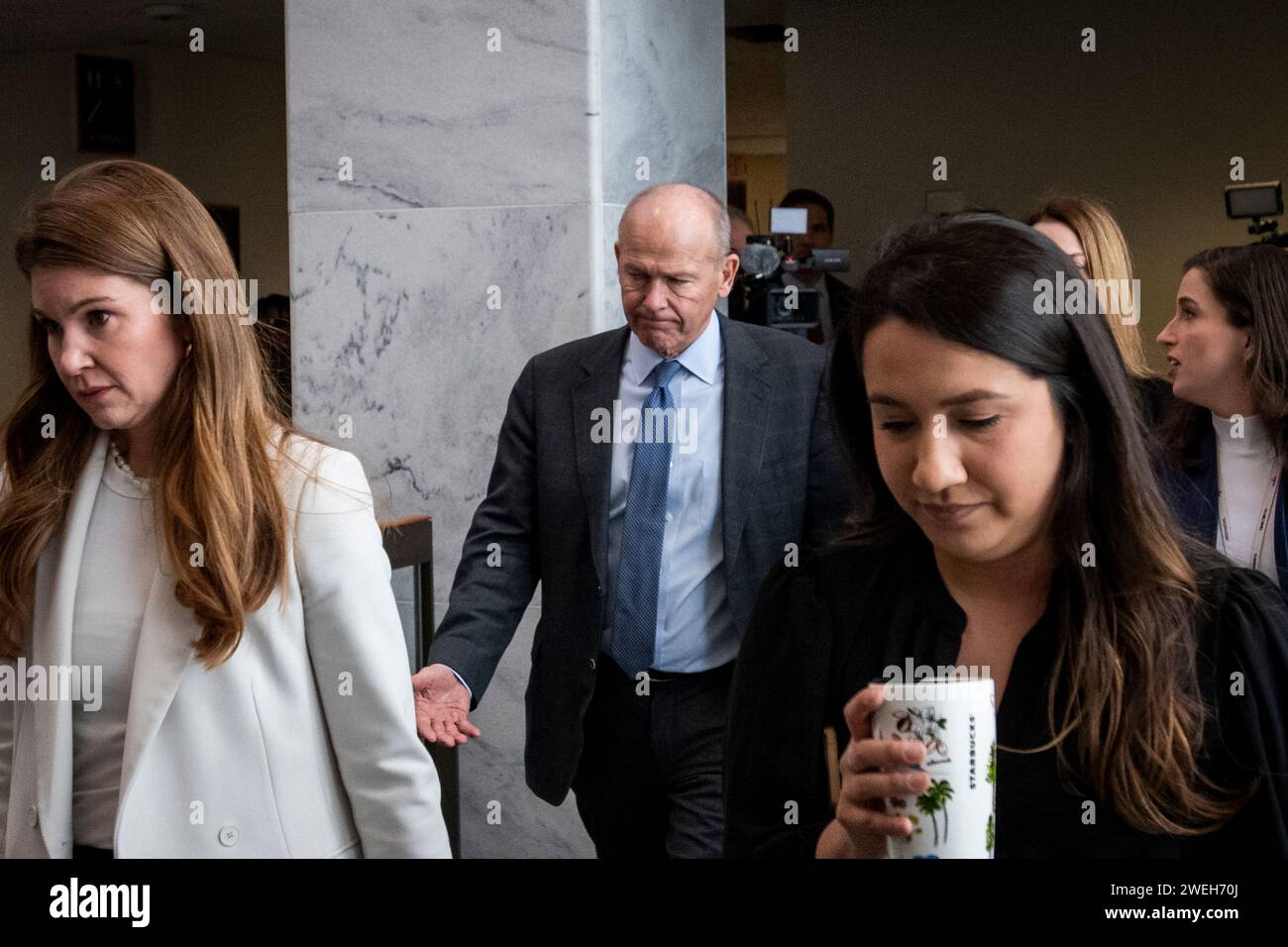 Boeing CEO Dave Calhoun is followed by reporters as he arrives at the ...