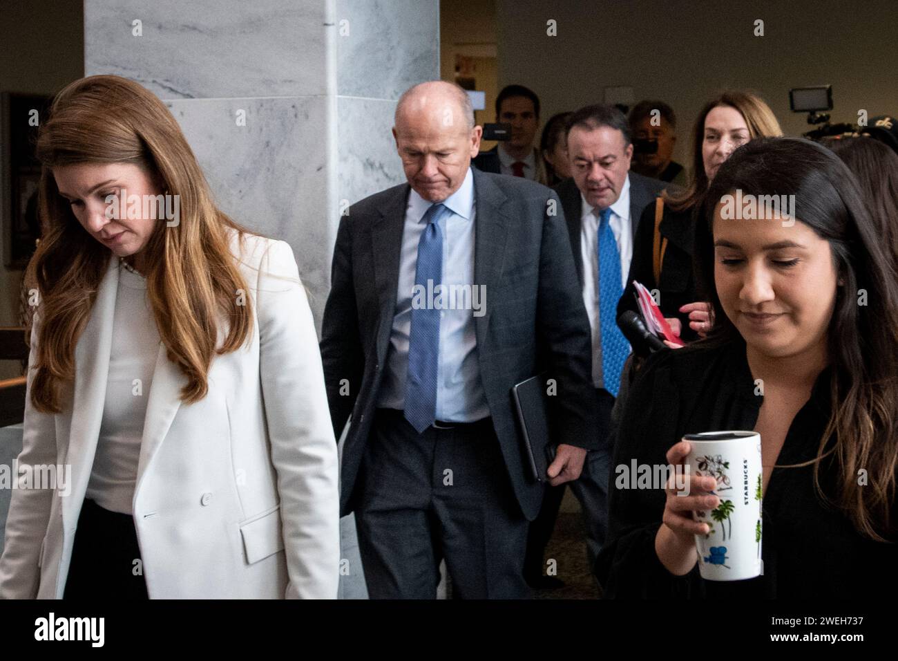 Boeing CEO Dave Calhoun is followed by reporters as he arrives at the ...