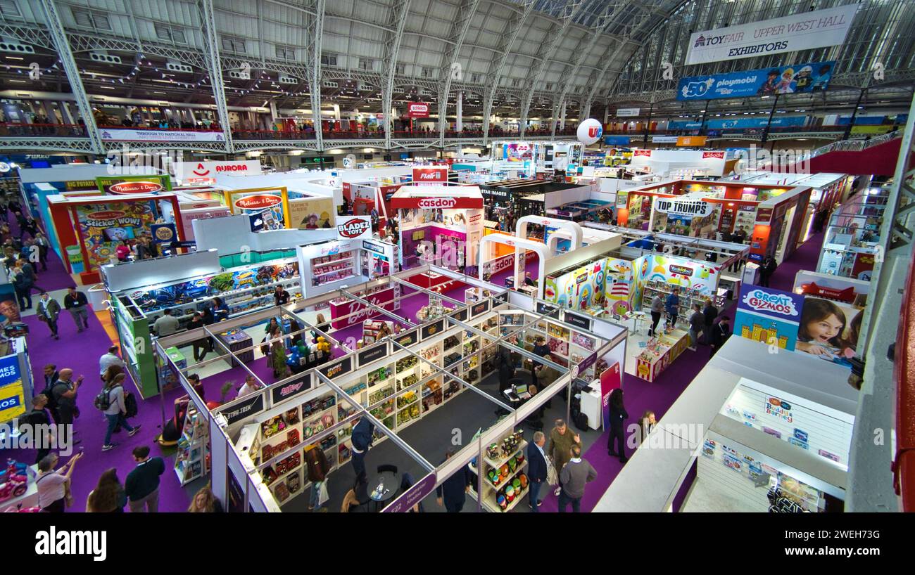 Several individuals in a spacious indoor exhibit hall, surrounded by ...