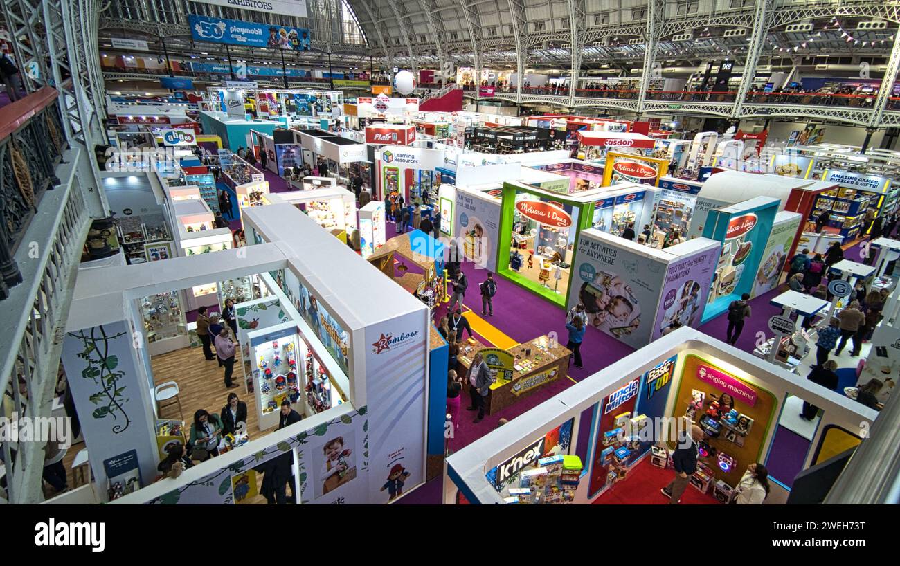 Several individuals in a spacious indoor exhibit hall, surrounded by ...