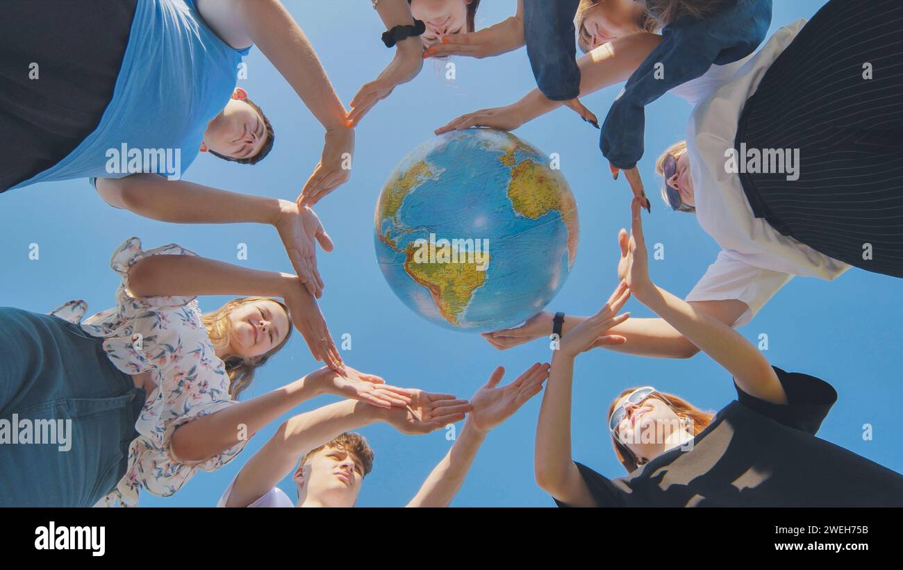 Group of people around a world map hi-res stock photography and images ...
