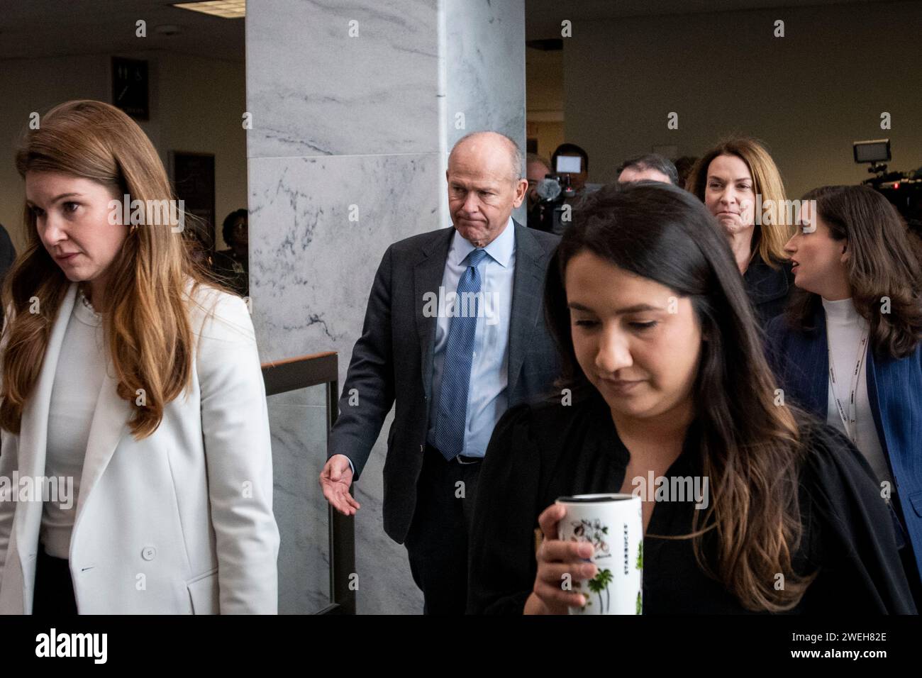 Boeing CEO Dave Calhoun is followed by reporters as he arrives at the ...