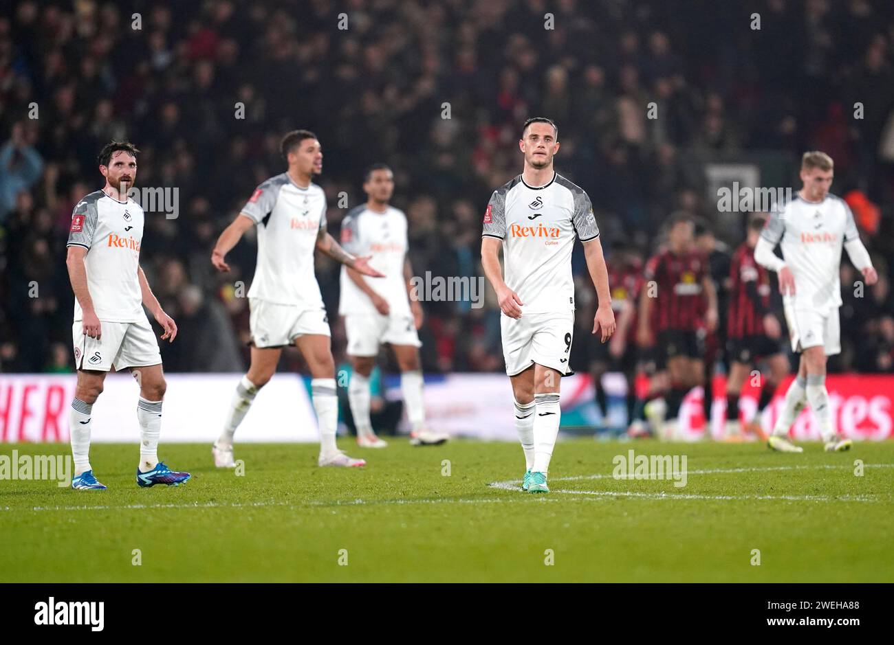 Swansea City's Jerry Yates (centre) and team-mates appear dejected ...