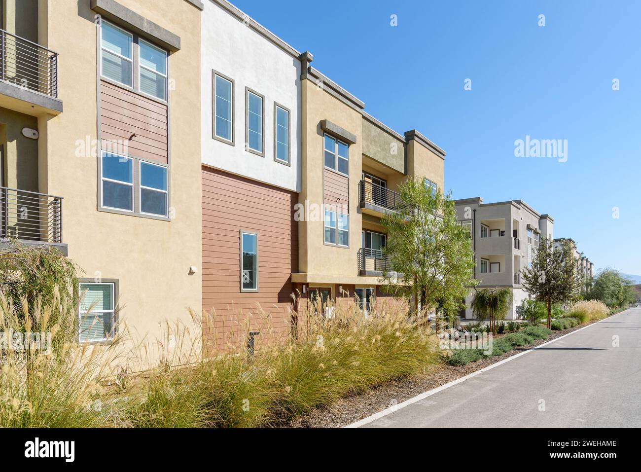 New apartment building in a suburban development on a clear autumn day ...