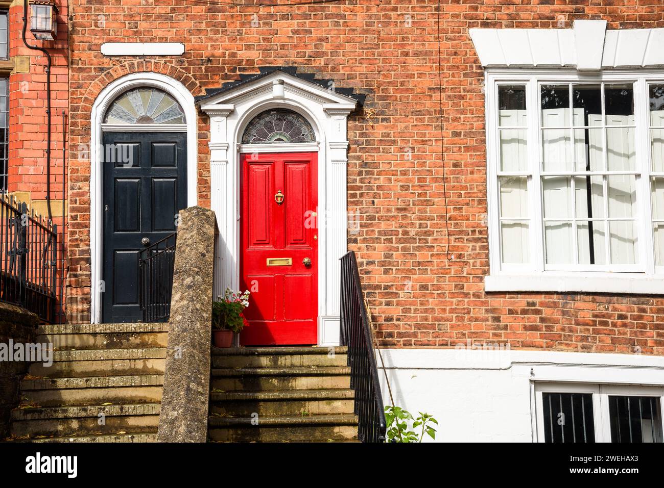 Colourful wooden front doors of traditional British red-brick ...