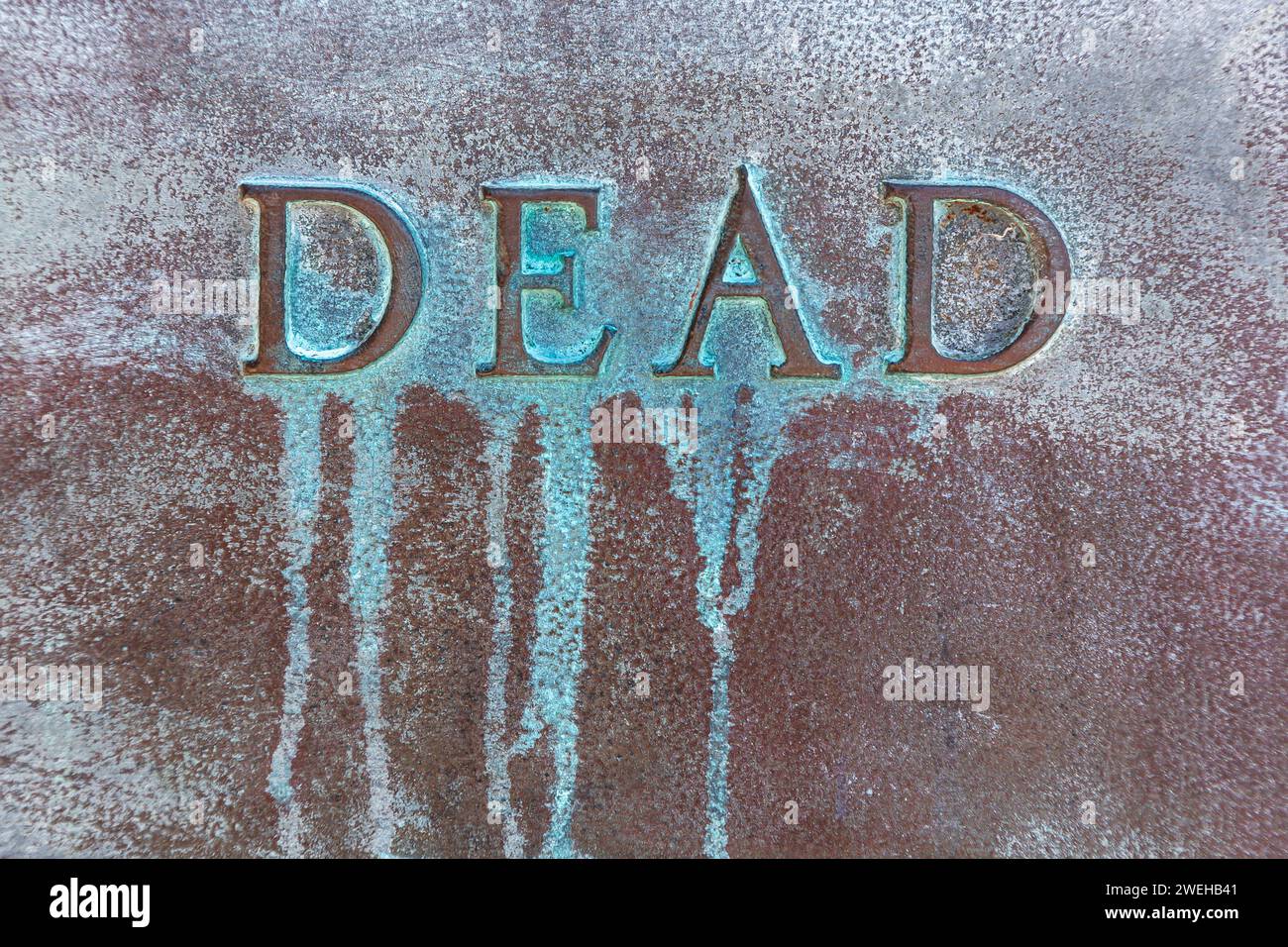DEAD: Lettering DEAD on a bronze plate. Close-up of word DEAD on a ...