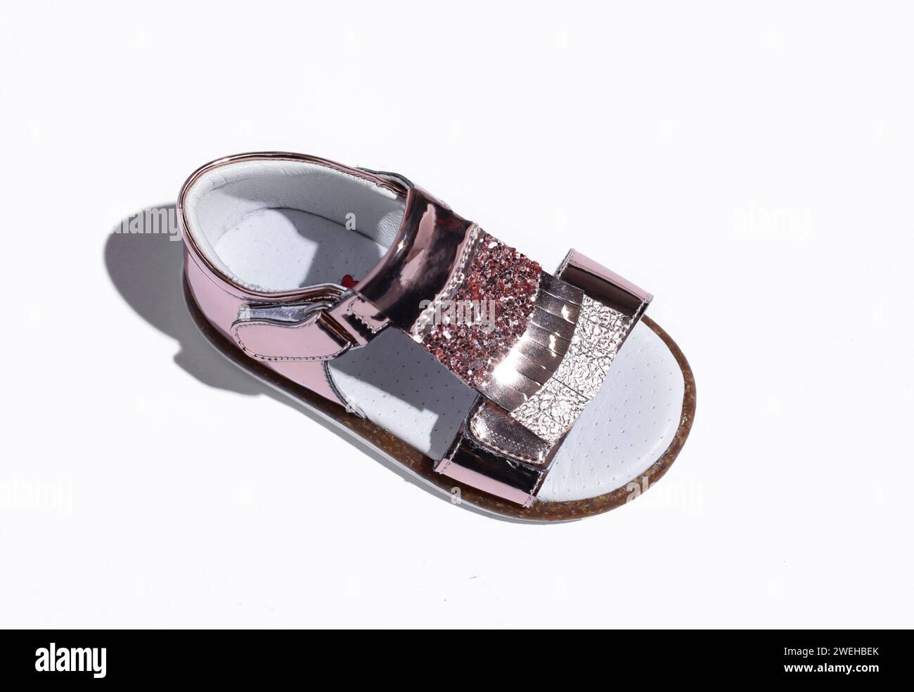 Side upper view of pink suede girl sandal, and velcros, isolated on ...