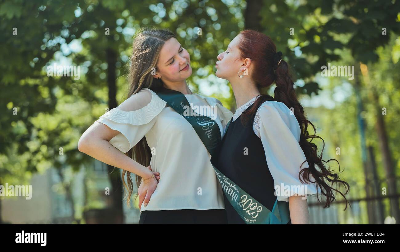 Two high school senior girls playfully sort of kissing Stock Photo - Alamy